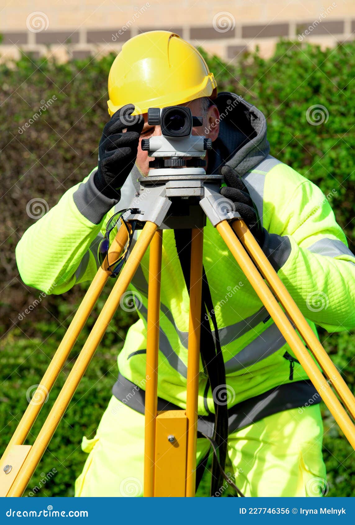 Surveyor Using Autolevel To Check Levels on New Housing Development ...