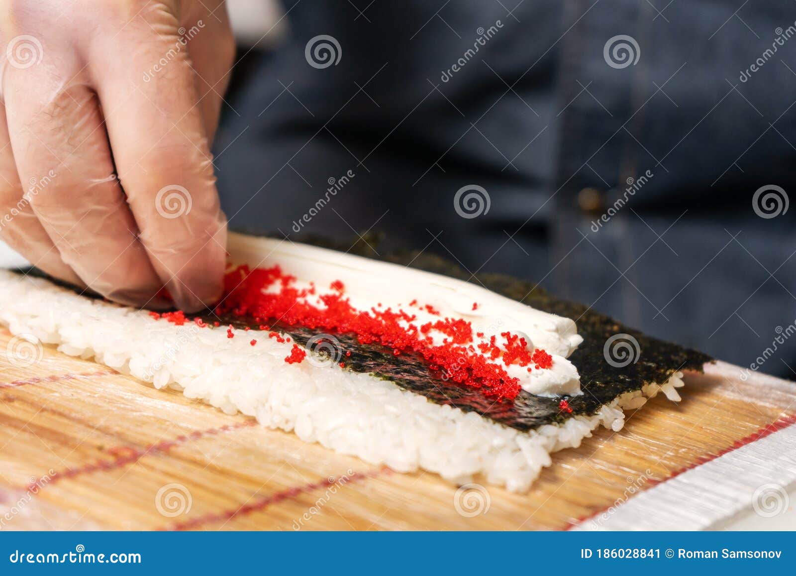 Sushi Chef Puts Red Masago Caviar in a Roll Stock Image - Image of nori ...
