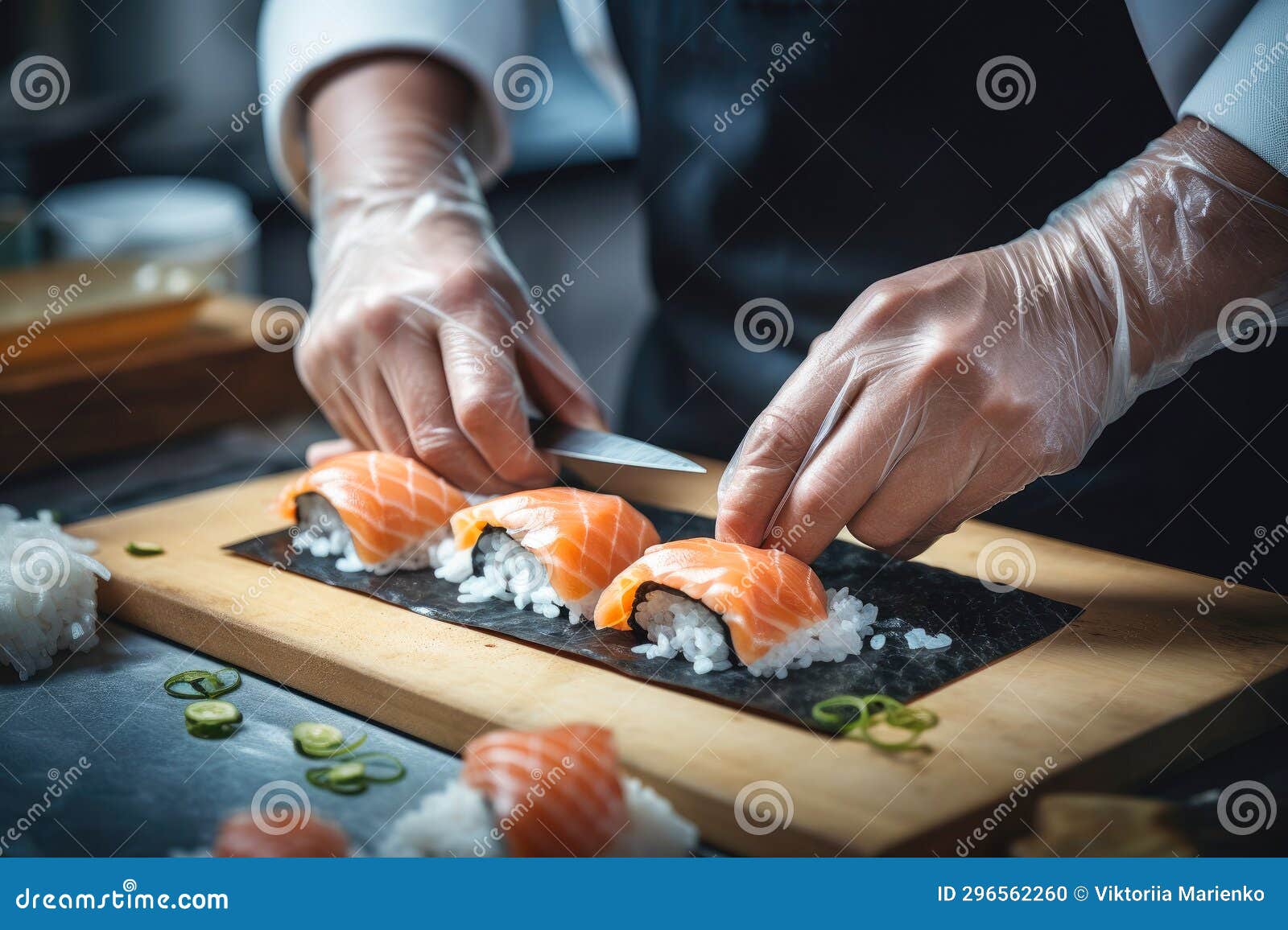 Sushi Chefs Making Delicious Rolls With Cucumber, Tobiko And Salmon ...