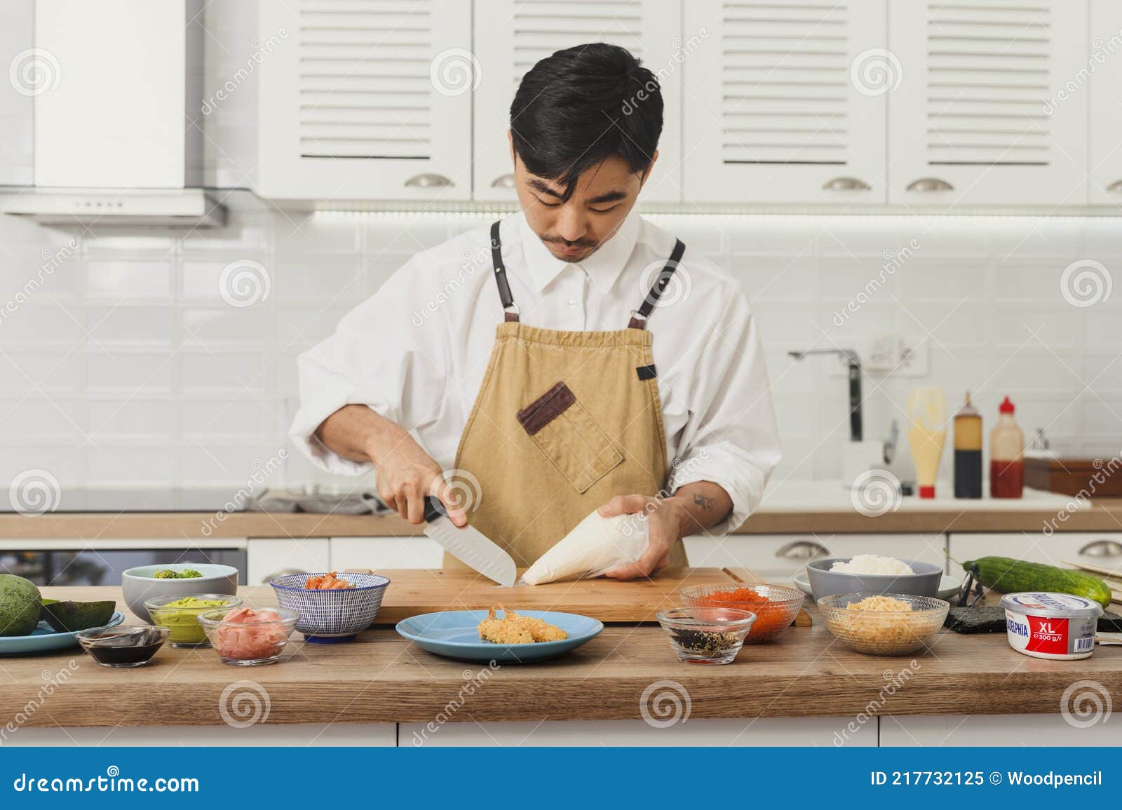 Sushi Master Chef Making Rolls on Chopping Board in the Kitchen ...