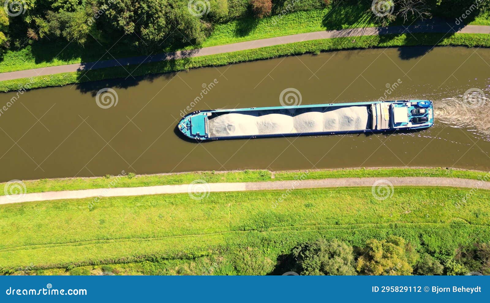 Sandy Voyage: Top-down Aerial of Cargo Ship Amidst Green Dikes Stock ...