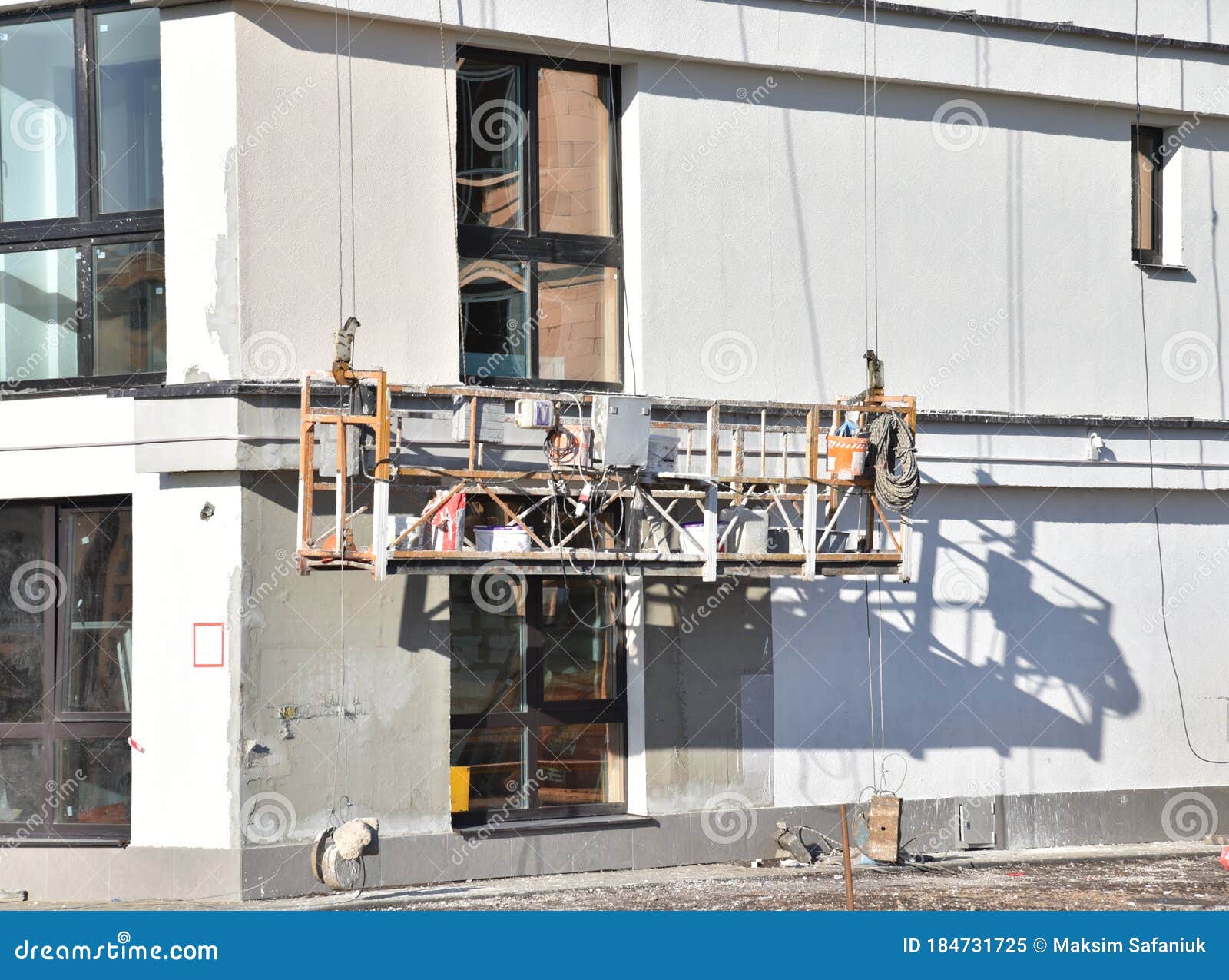 Suspended Construction Cradle on the Background Facade of the Building ...