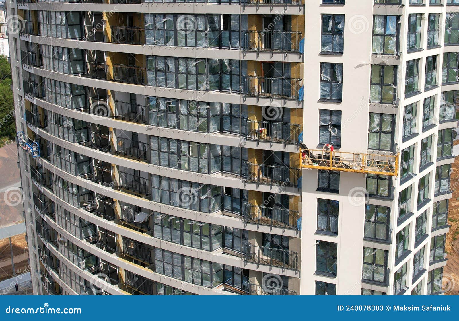 Suspended Cradle for Works of the Facade of Skyscraper. Construction of ...
