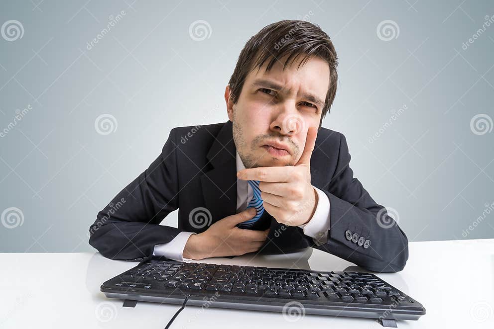Suspicious Businessman is Looking at Screen at Work Stock Photo - Image ...