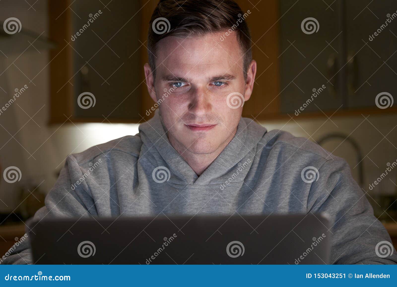 Suspicious Looking Man Using Laptop in Evening at Home Stock Image ...