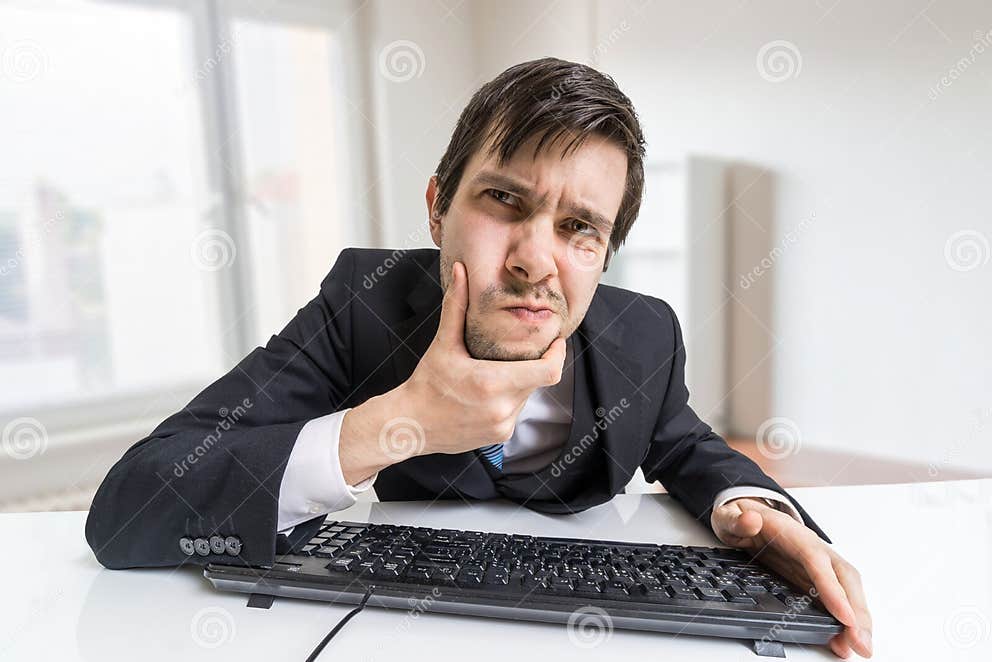 Suspicious Man is Working with Computer and Looking on Screen Stock ...