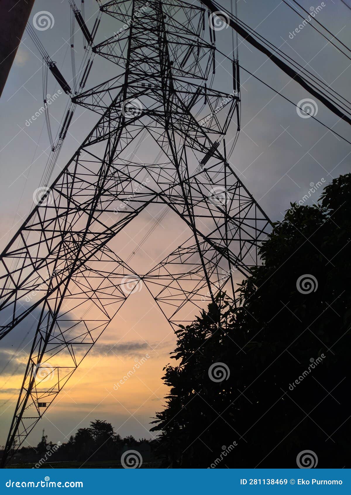 A Tower with High-voltage Power Lines at Sunset or Sunrise Stock Image ...