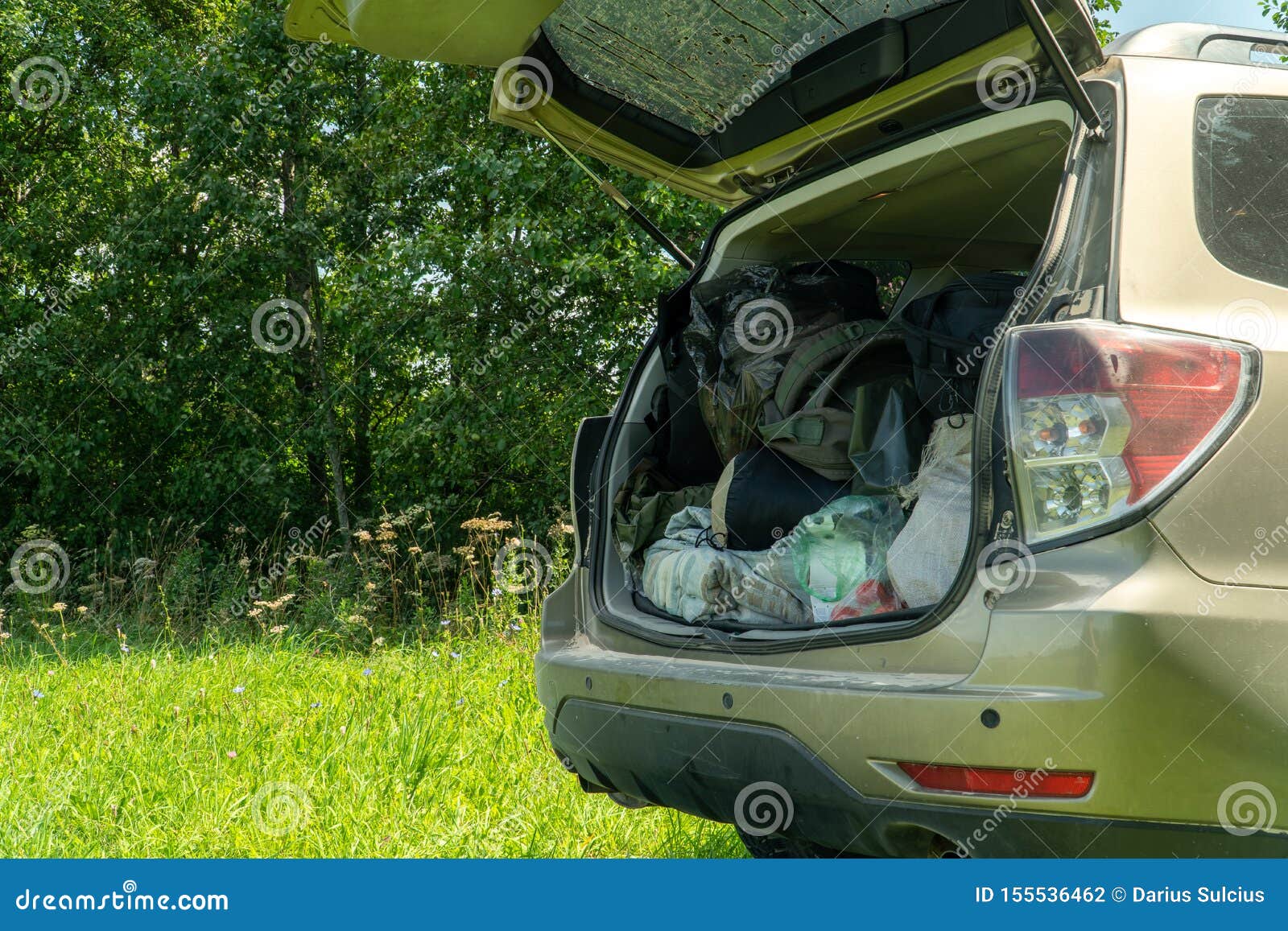 SUV with Open Boot Packed Full of Camping Equipment. Outdoors Scenery ...