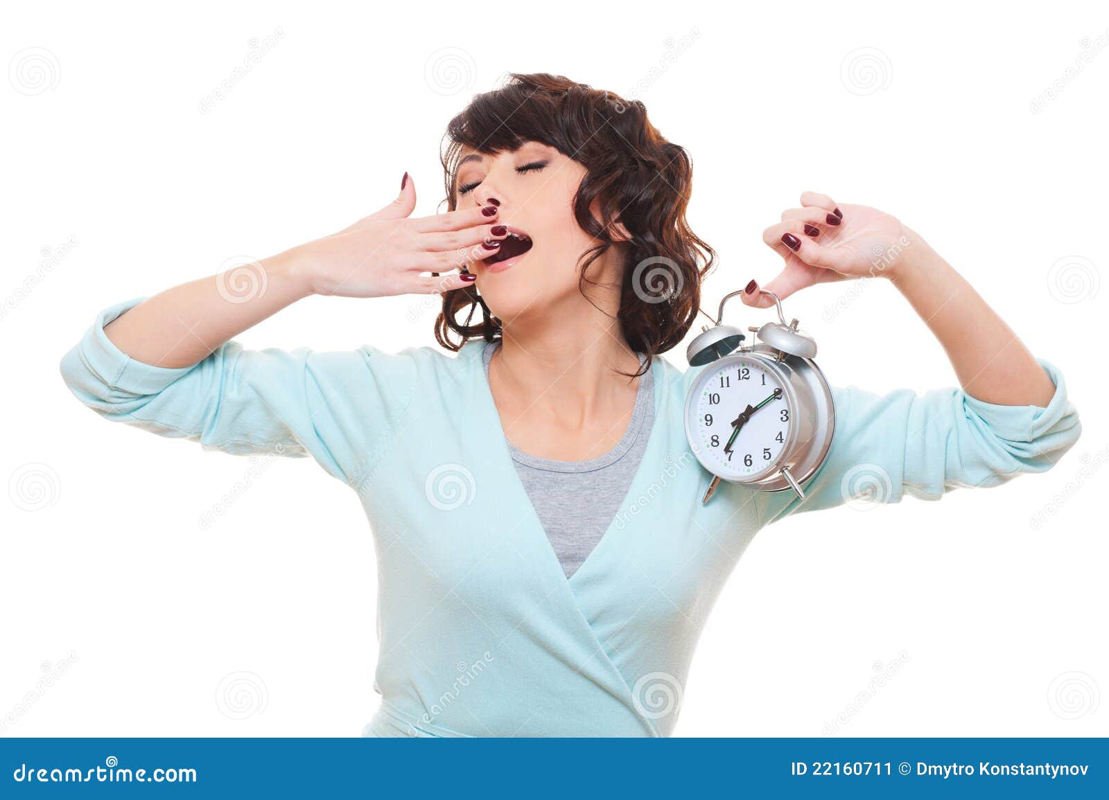 Sveglia Della Holding Della Donna E Sbadigliare Immagine Stock ...