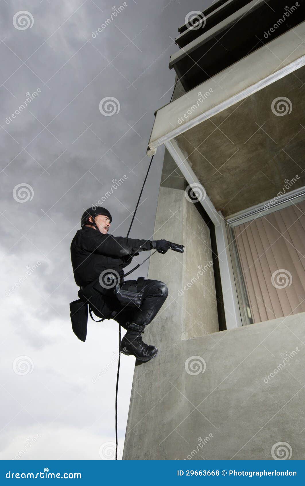 SWAT Team Officer Rappelling and Aiming Gun Stock Photo - Image of ...