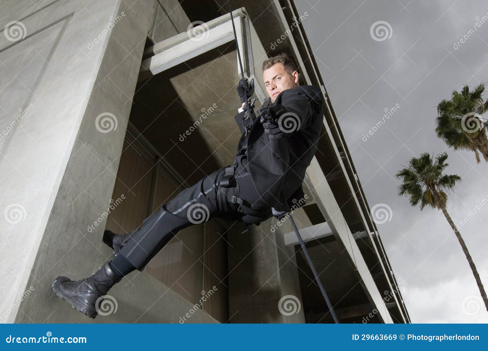 SWAT Team Officer Rappelling and Aiming Gun Stock Image - Image of ...