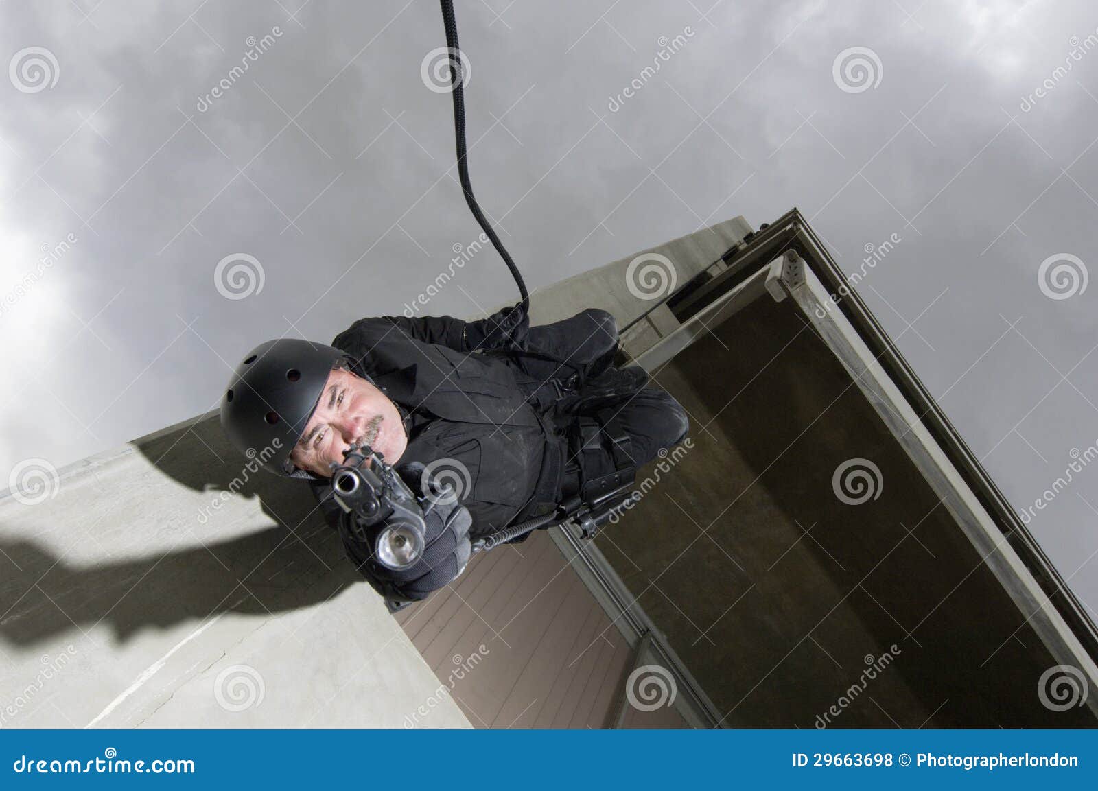 SWAT Team Officer Rappelling and Aiming Gun Stock Photo - Image of ...