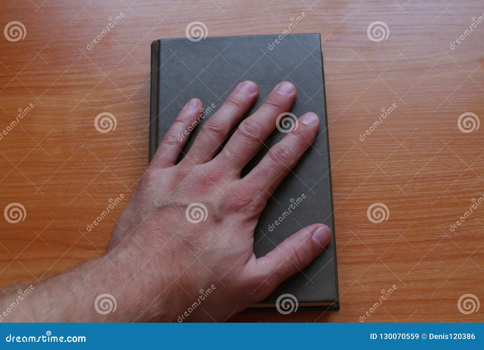 The hand on the book stock image. Image of swearing - 130070559