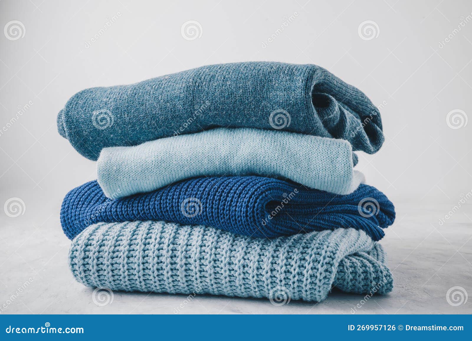 Sweaters. Blue Sweaters Stacked on Gray Background Stock Photo - Image ...