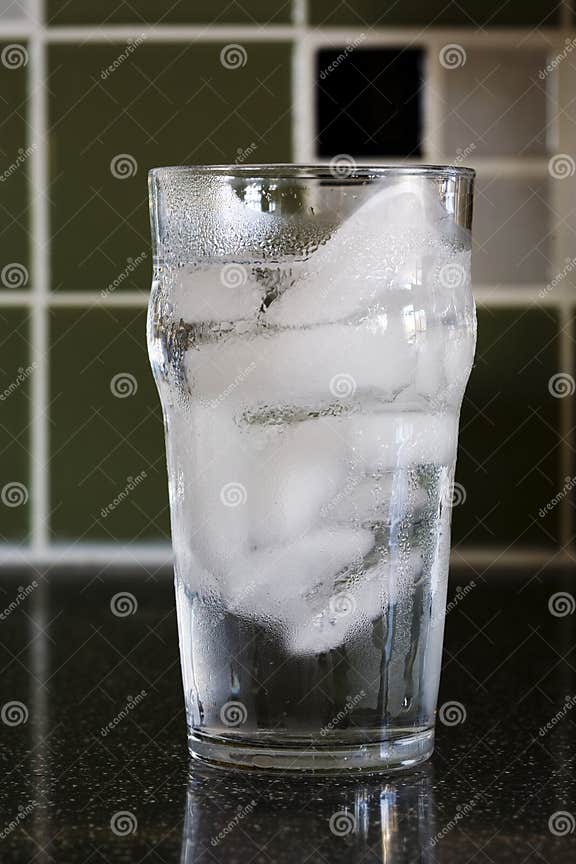 Sweating Class of Cold Water and Ice Cubes Stock Photo - Image of water ...