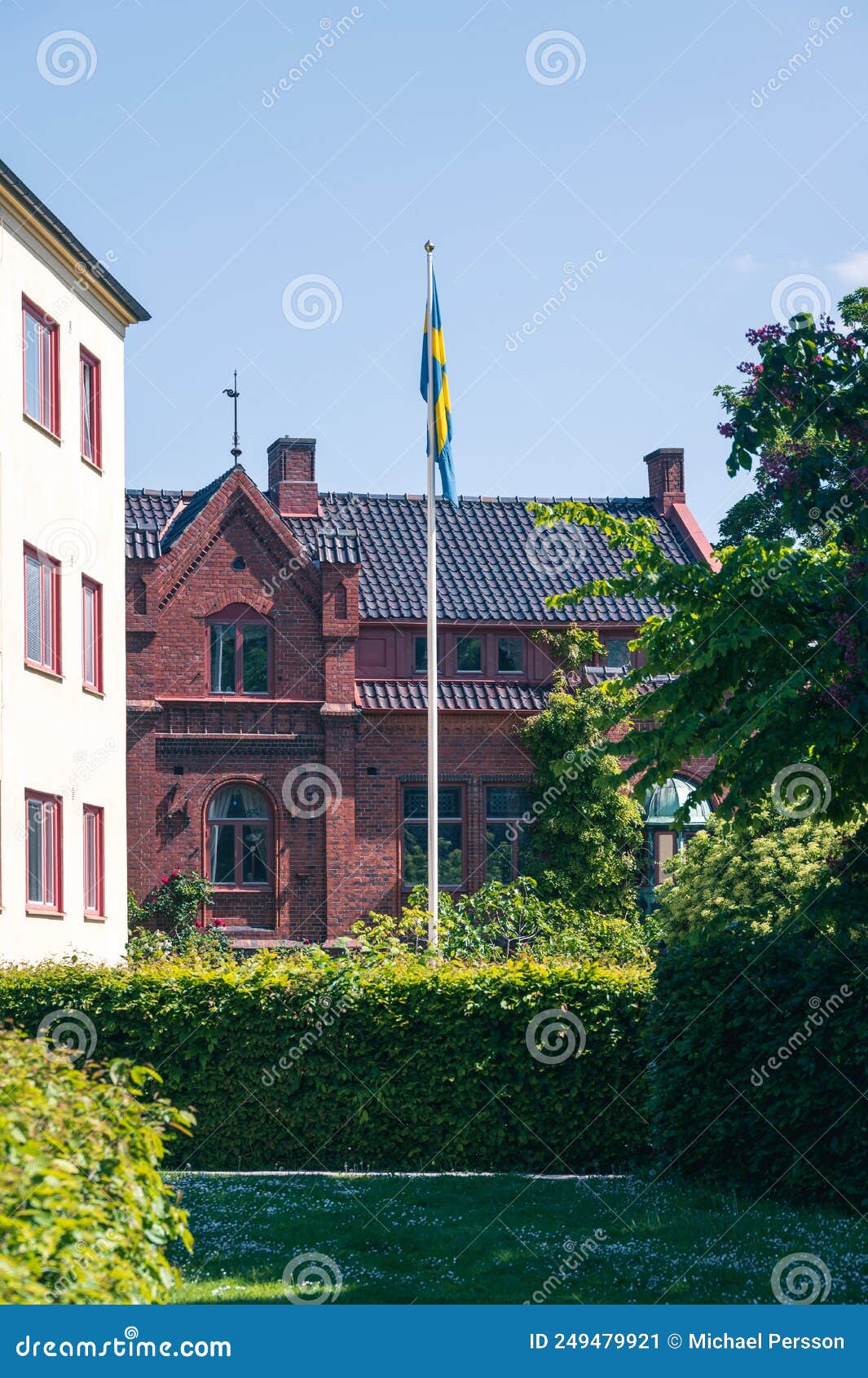 Swedish Flag on Flag Pole in Front of Red Brick Building in Summer Time ...