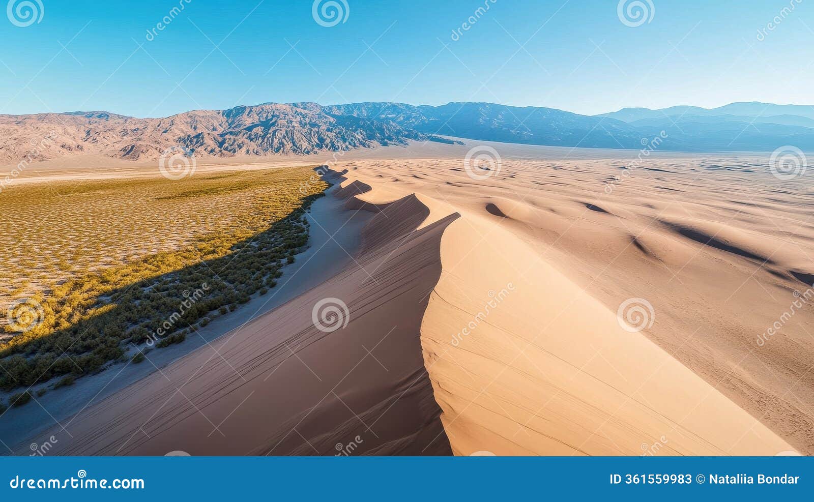 Sweeping Aerial View of Desert Sand Dunes and Vast Mountain Range ...