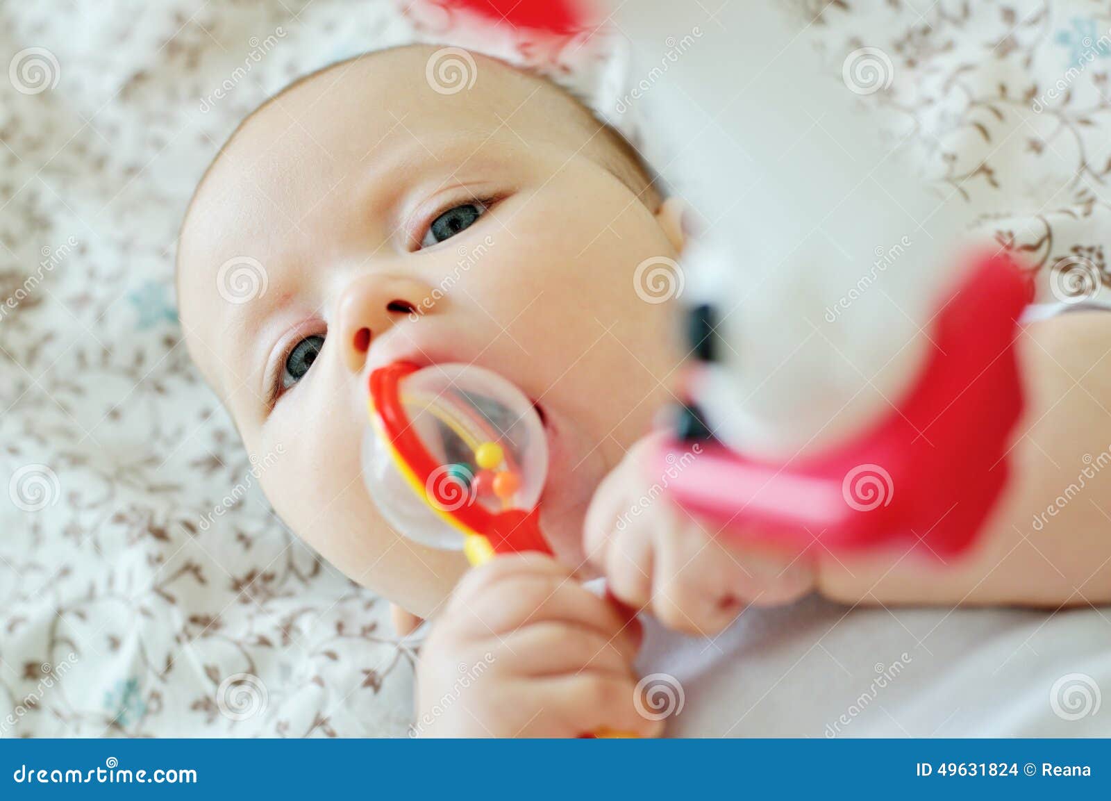 Sweet baby biting a toy stock photo. Image of person - 49631824