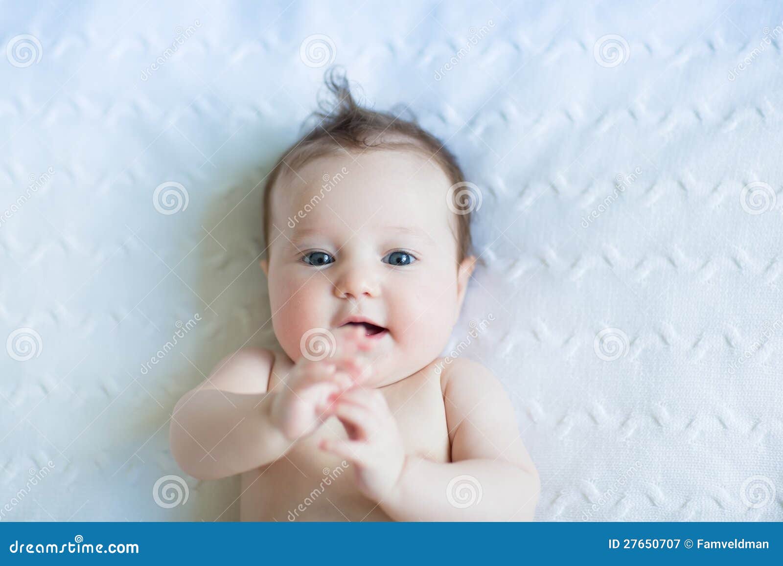 Sweet Baby on a White Blanket Playing with Its Hands Stock Image ...