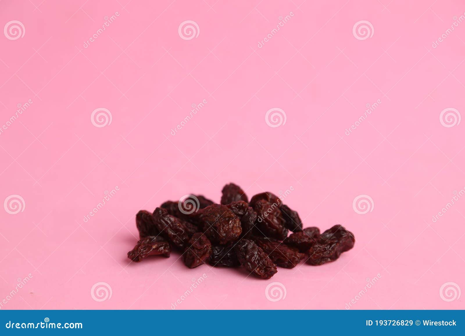 Sweet Black Dried Raisins in the Bowl on the Pink Surface Stock Image ...