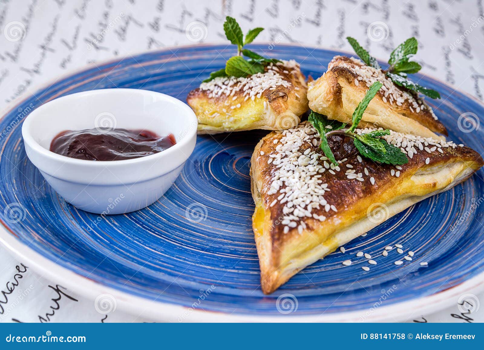 Sweet Cakes Triangular Shape with Sesame Seeds and Jam Stock Photo ...