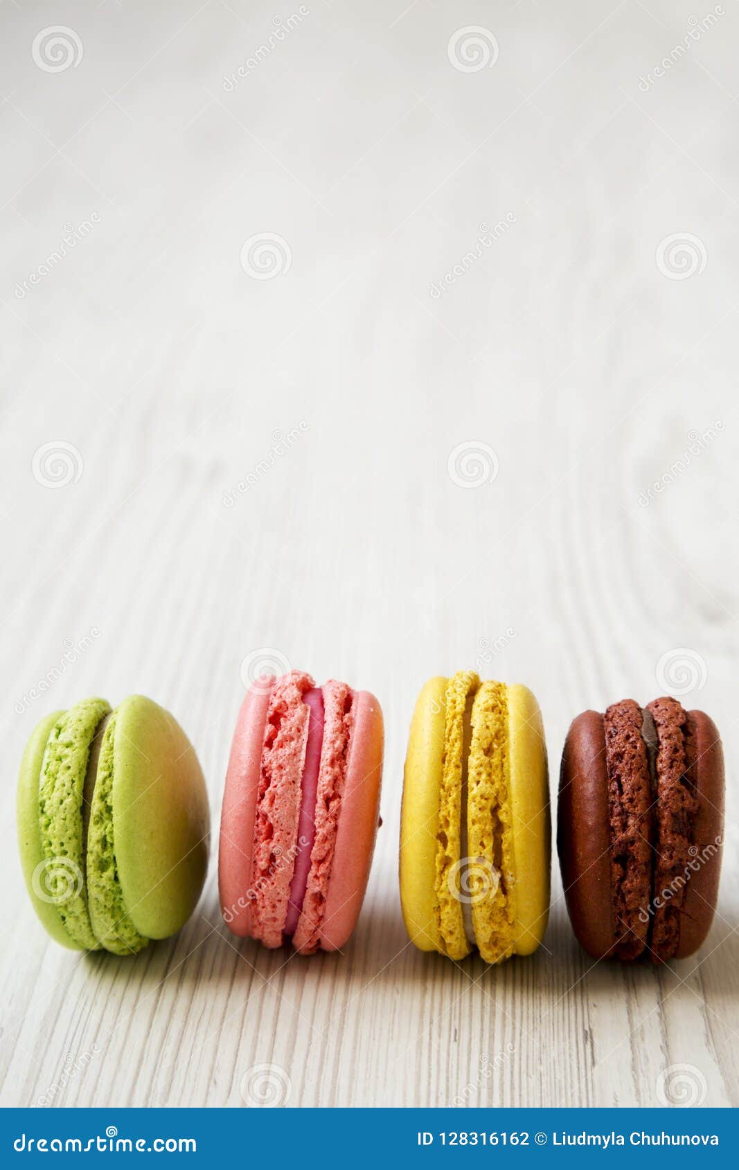 Sweet and Colorful Macarons on a White Wooden Surface, Side View. Copy ...