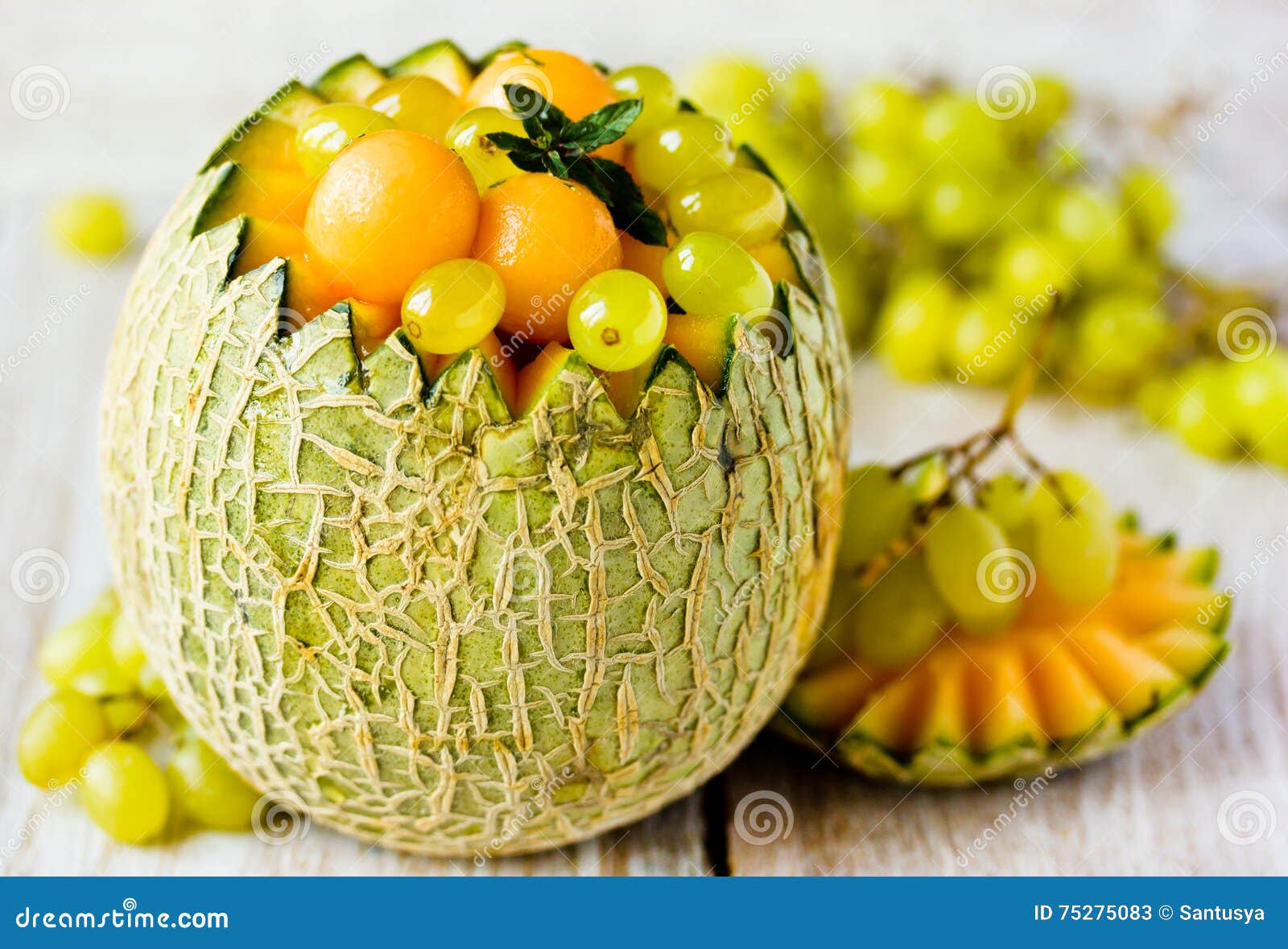 Sweet Dessert Summer Salad of Melon, Grapes and Mint on White Ba Stock ...