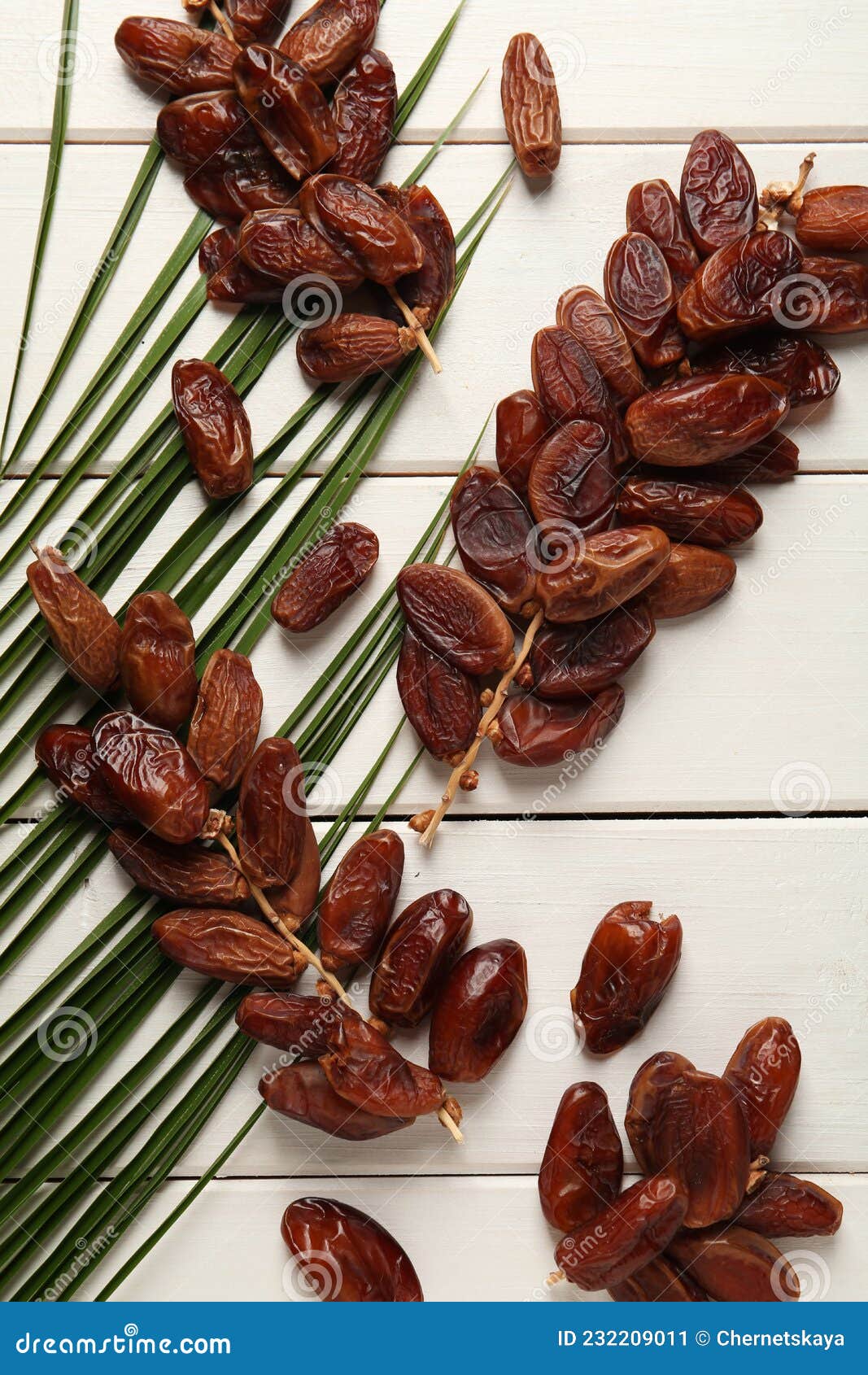 Sweet Dried Dates with Palm Leaf on White Wooden Table, Flat Lay Stock ...