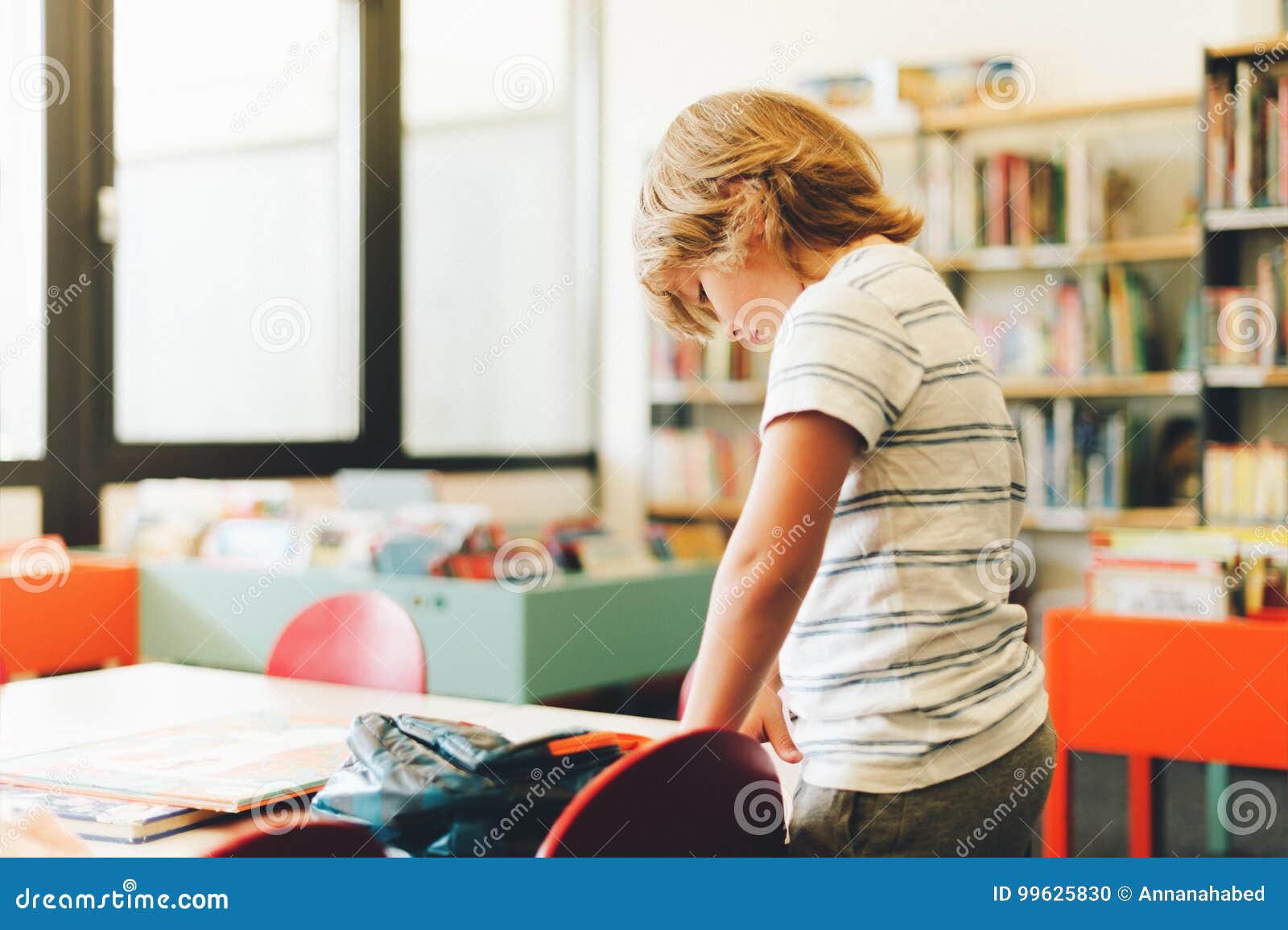 Sweet Little Boy Packing Backpack in Classroom Stock Photo - Image of ...