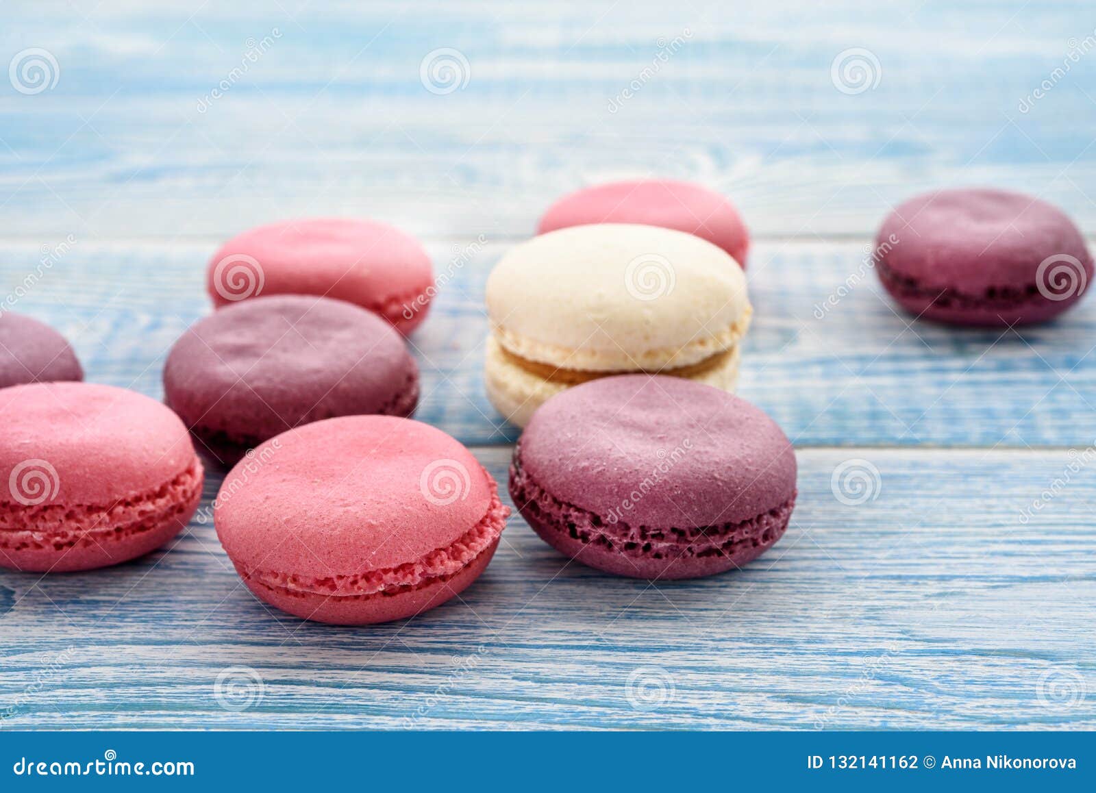 Sweet Macarons on a Blue Background. Trendy Cakes Stock Photo - Image ...