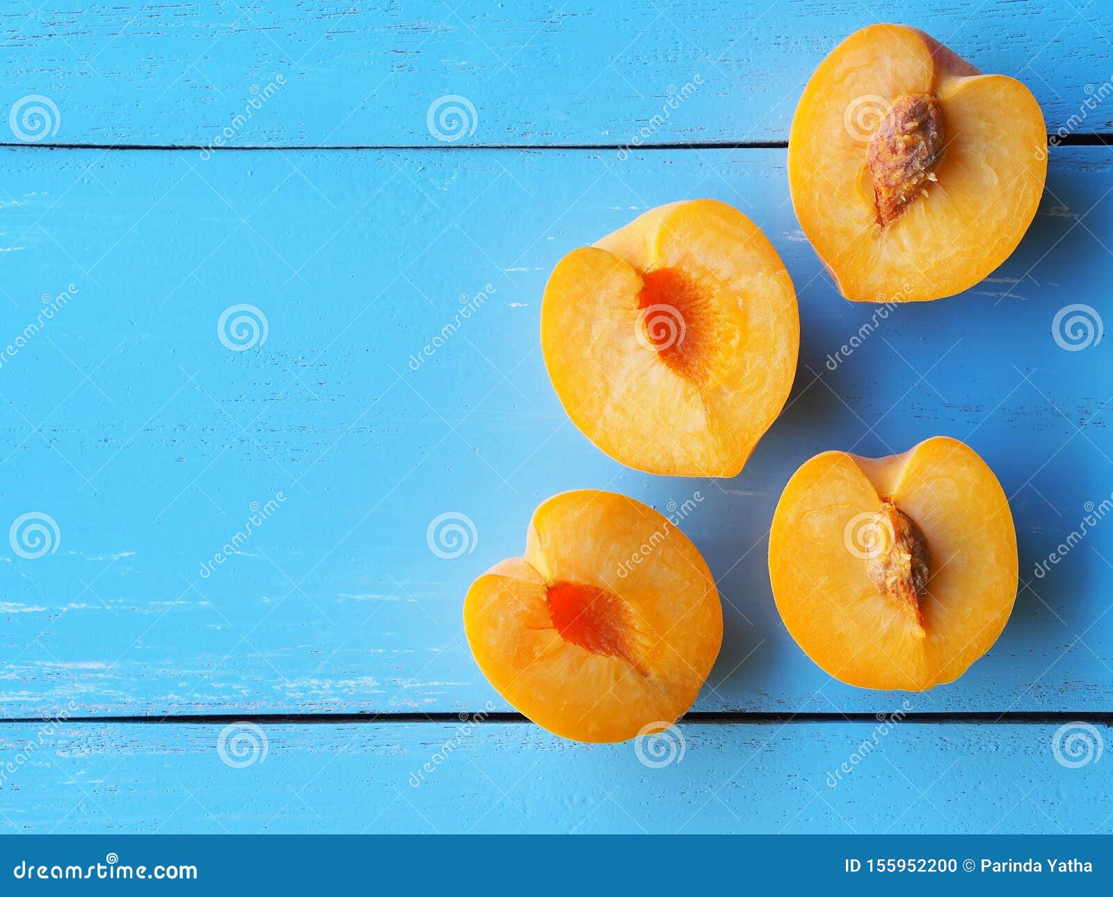 Sweet Peaches Cut in Half on the Blue Color Table. Stock Photo - Image ...