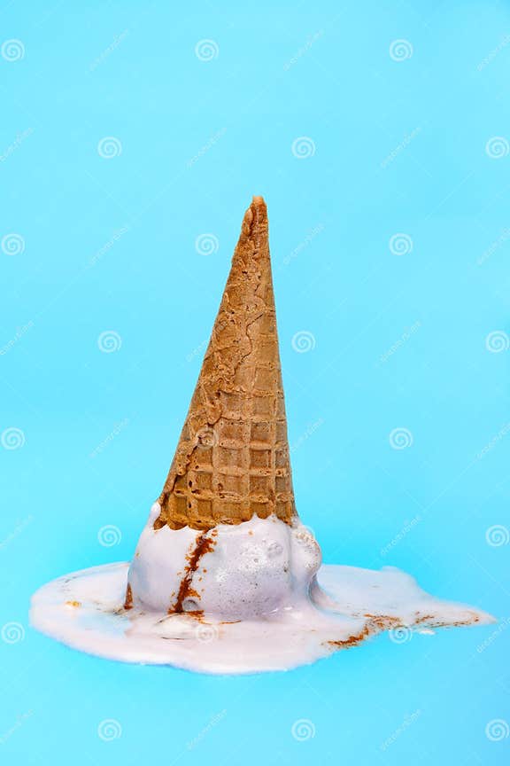 A Sweet Potato Flavor Ice Cream Cone Upside Down And Melted On Blue