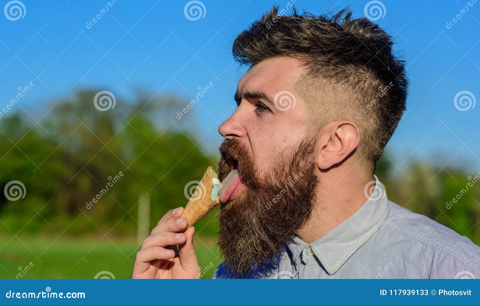 Sweet Tooth Concept Man With Long Beard Licks Ice Cream Stock Image