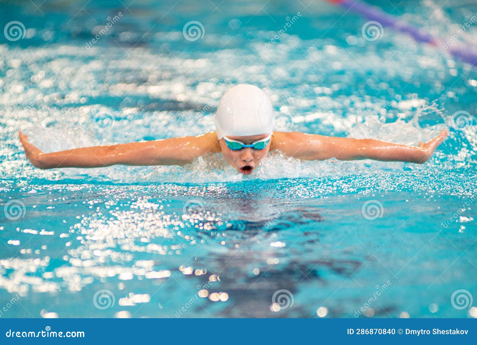 Swimmer Boy Swims Butterfly Swimming Style in the Pool Stock Photo ... Swimmer Boy Swims Butterfly Swimming Style in the Pool Stock Photo ...