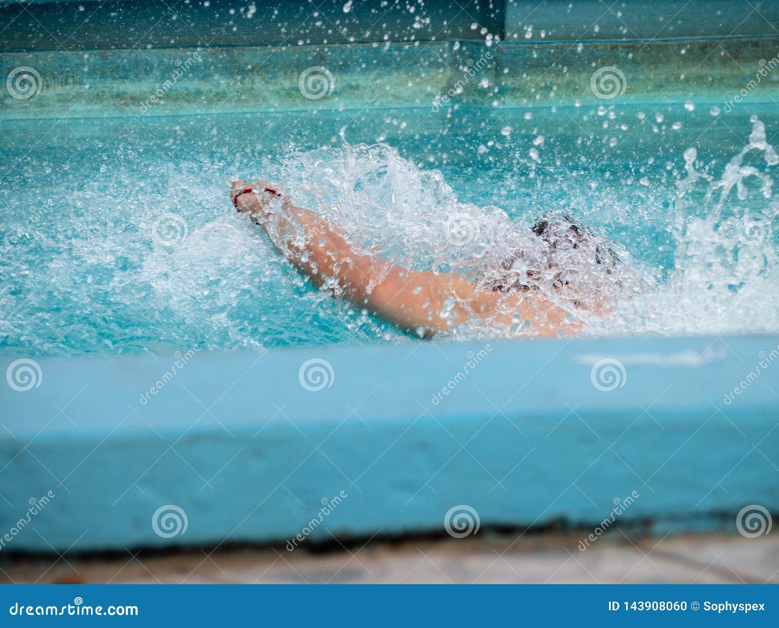 Swimmer Splashing Water in a Blue Swimming Pool Stock Photo - Image of ...