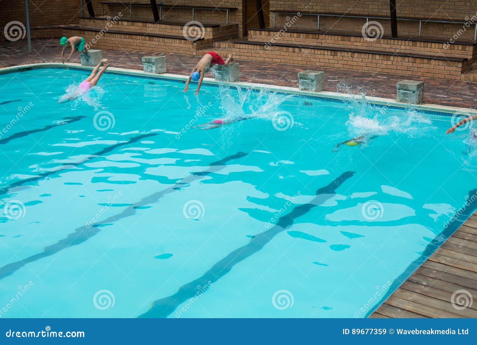 Swimmers diving into pool stock image. Image of child - 89677359