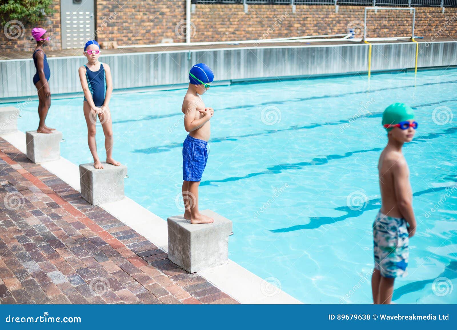 Swimmers Standing on Starting Blocks at Poolside Stock Photo - Image of ...