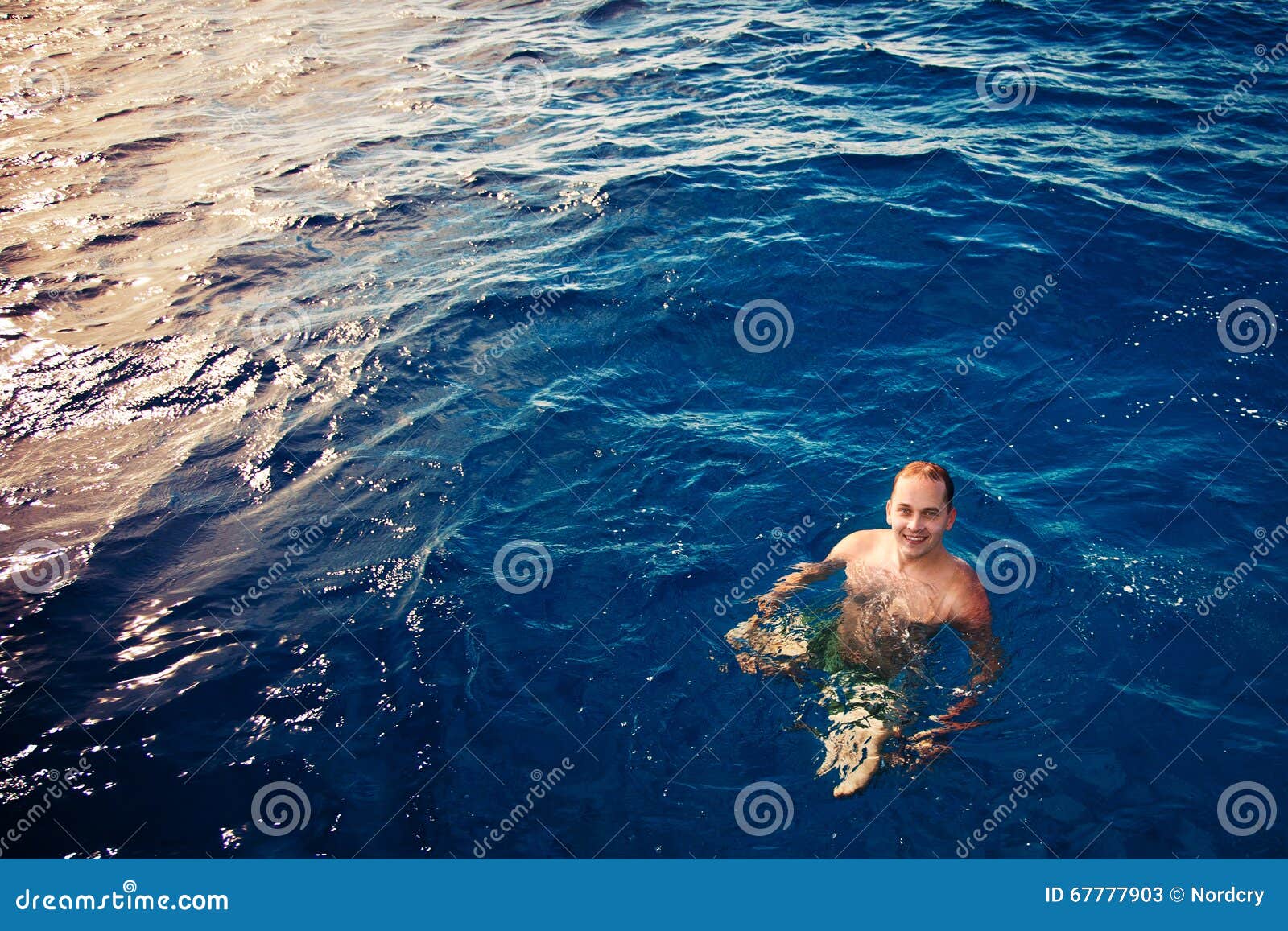 Swimming Man in Deep Blue Sea Stock Image - Image of warm, clean: 67777903