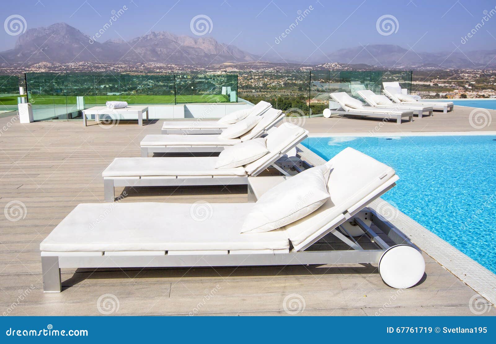 Swimming Pool Area with White Sun Beds at the Modern Resort. Stock ...