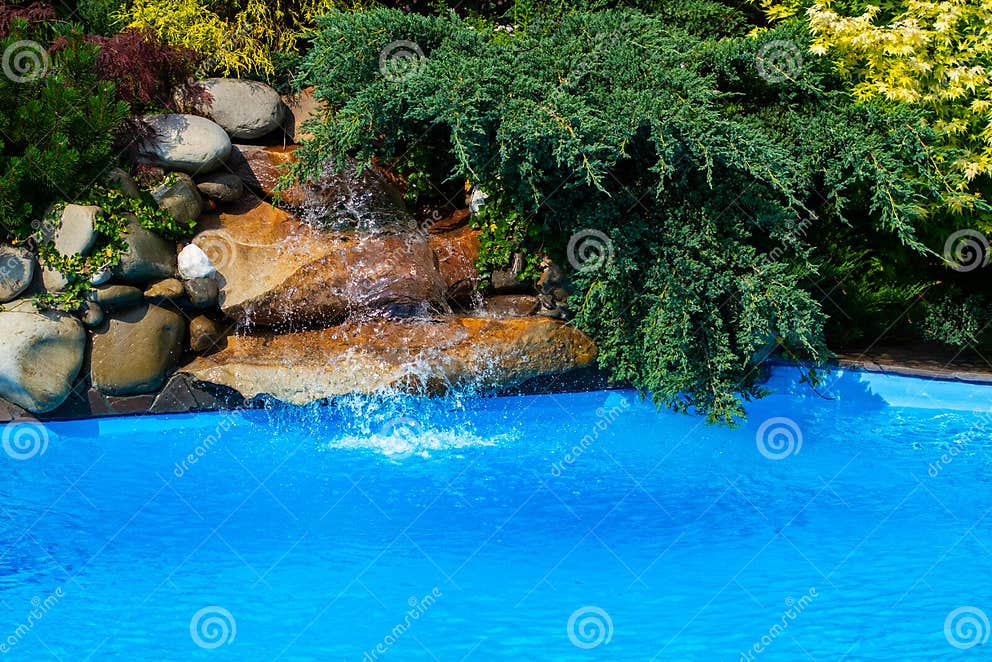 Swimming pool water fall stock photo. Image of reflection - 218638534