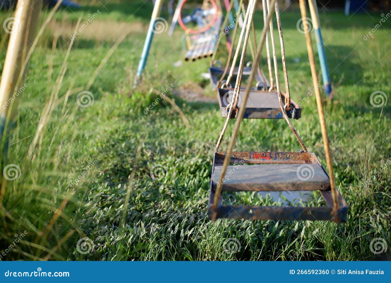 Swing on the Playground with Green Grass Field Stock Photo - Image of ...