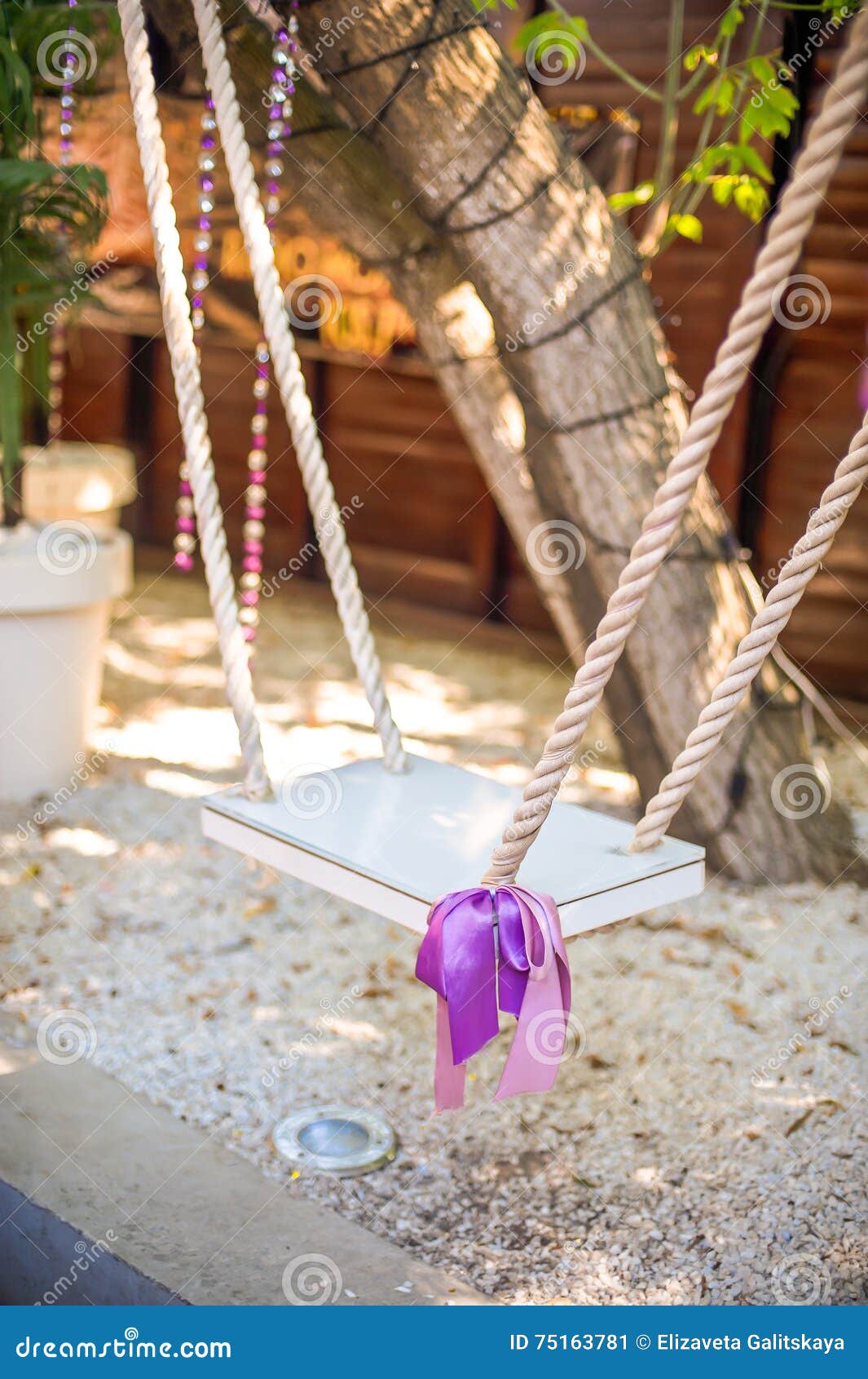 Swing with a purple bow stock image. Image of flower - 75163781