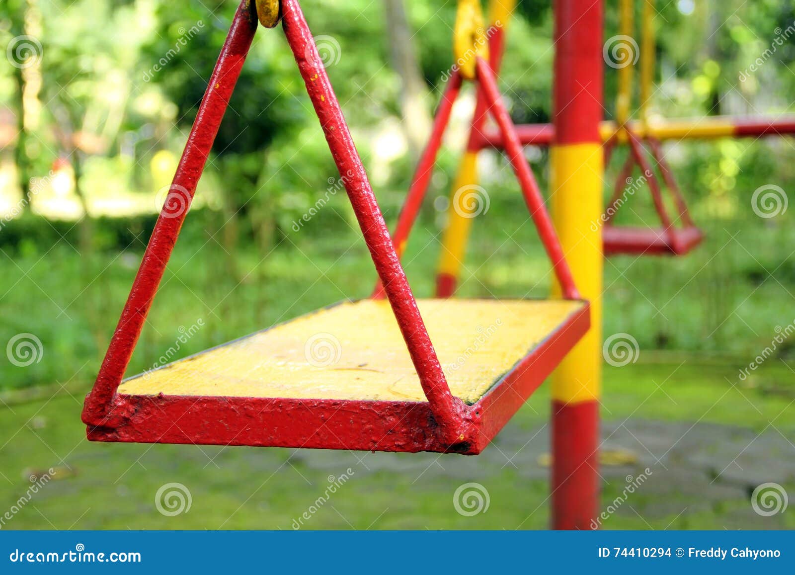 Swing set on a playground stock photo. Image of childhood - 74410294