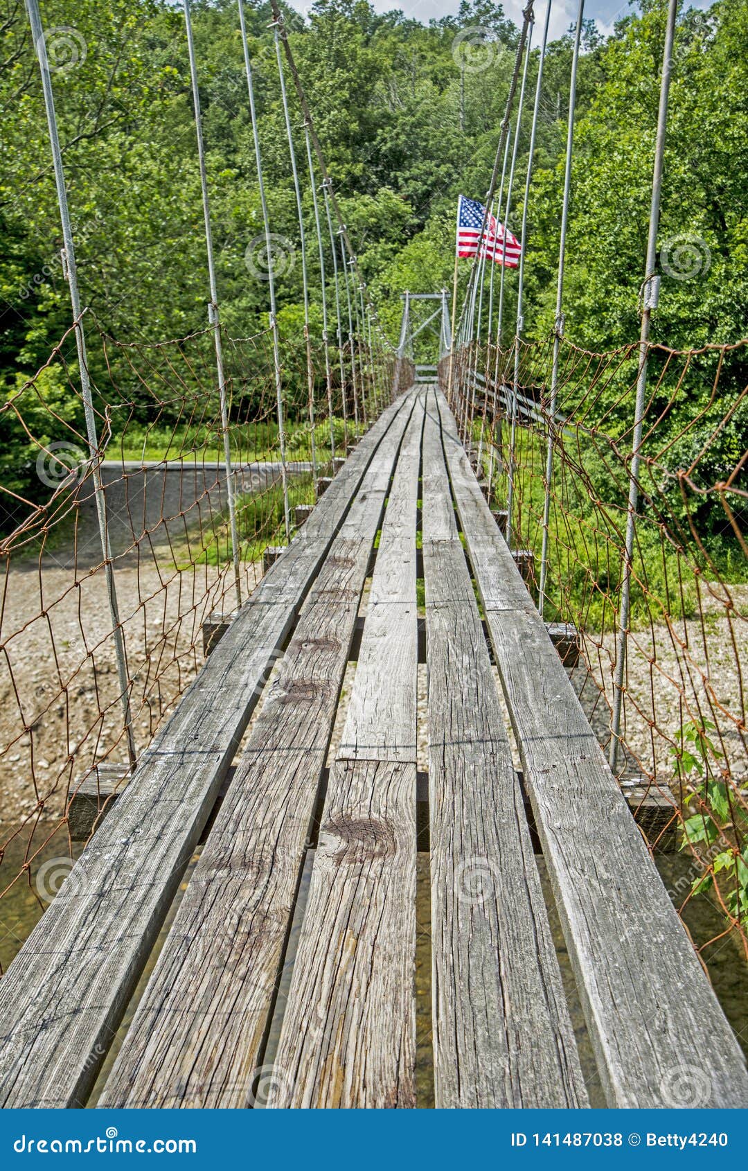 A Swinging Bridge with an American Flag Flying. Stock Photo - Image of ...