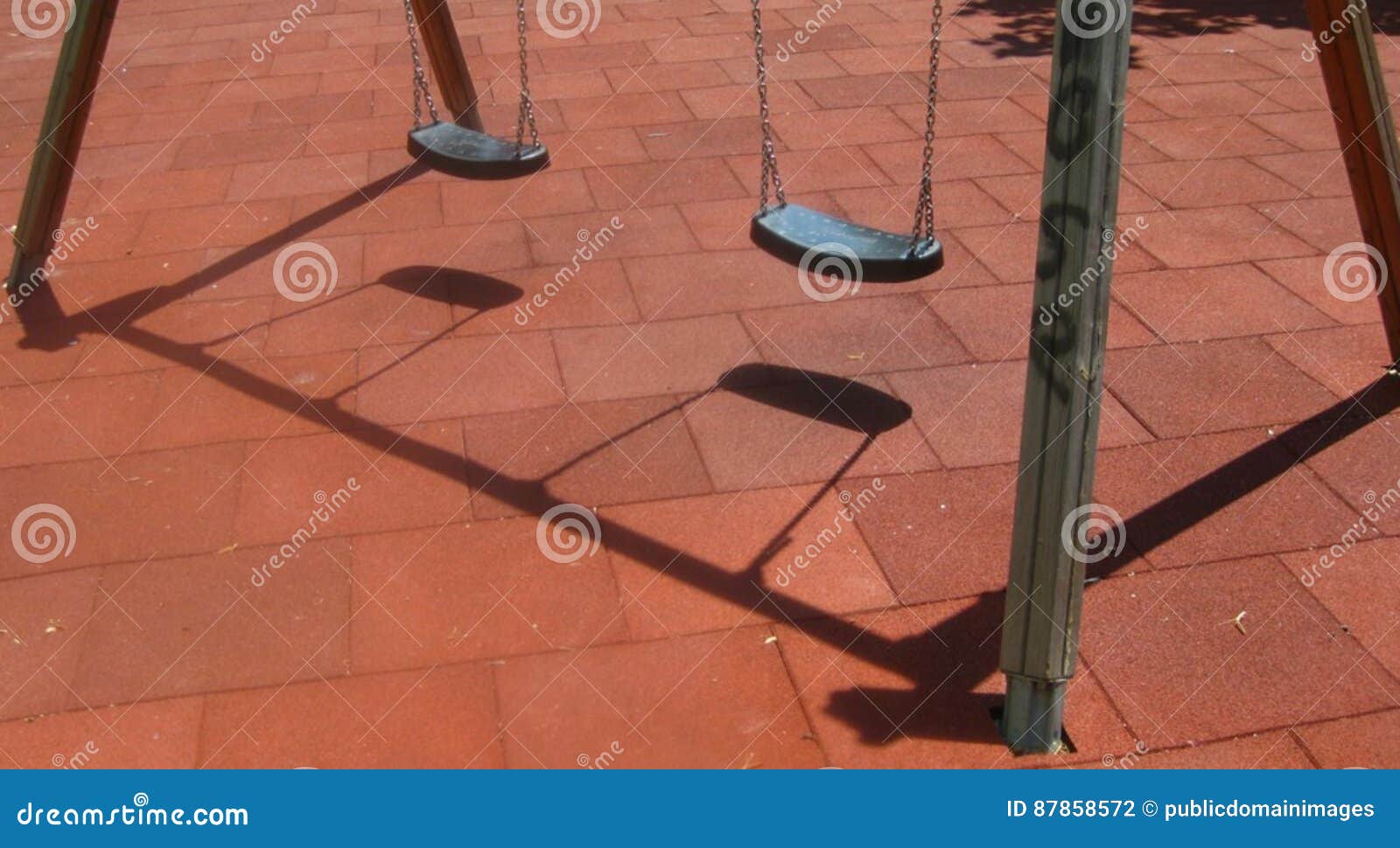 Swings-casting-shadow-on-playground Picture. Image: 87858572