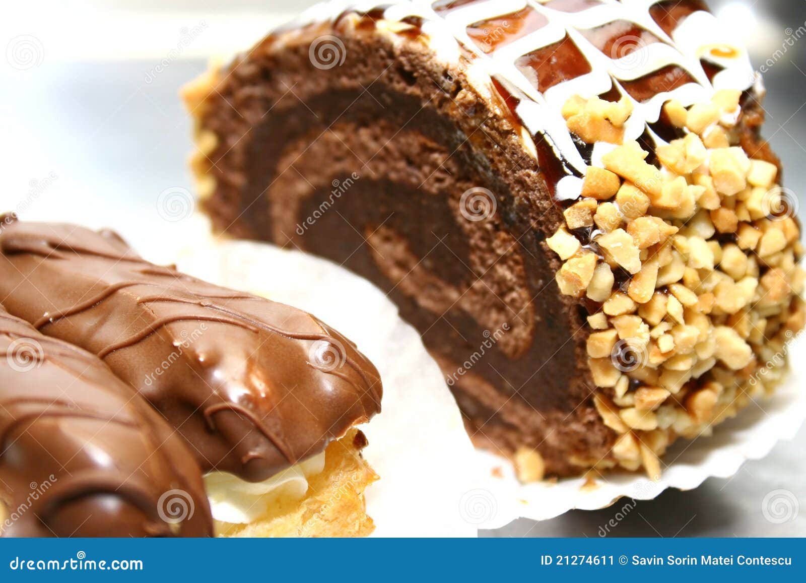 Swiss Roll With Nuts And Chocolate And Two Eclairs Royalty-Free Stock ...