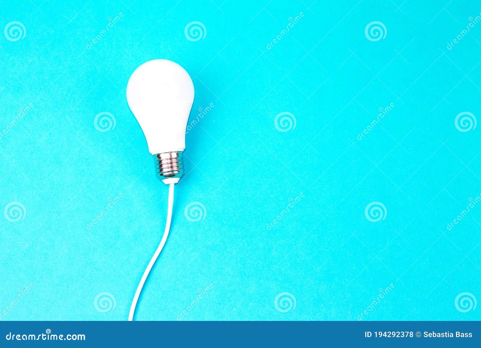 A Switched on Light Bulb on a Light Blue Background - a Symbol of a New ...