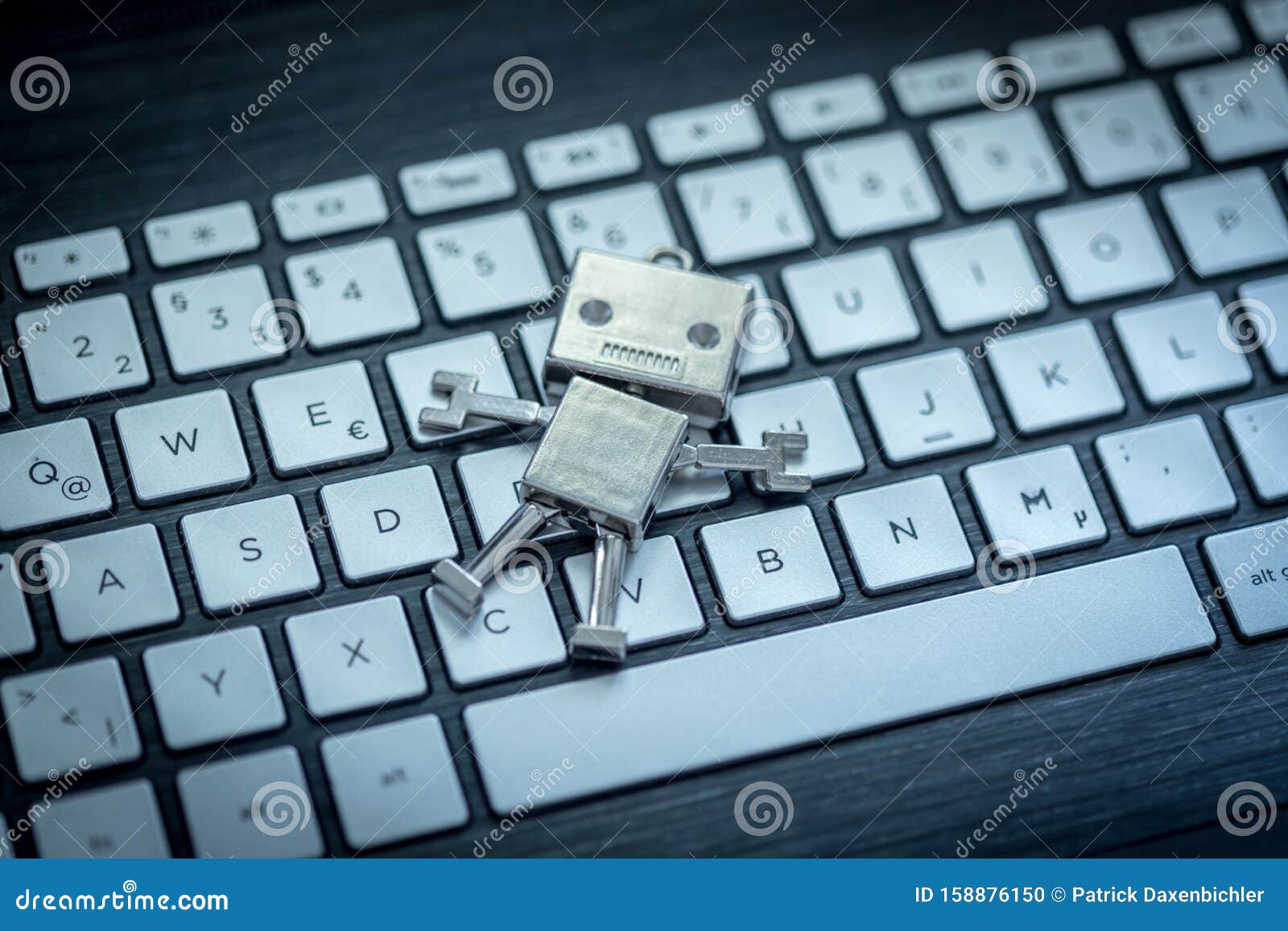 Symbol for a Chatbot or Social Bot. Toy Robot Lying on a Computer ...