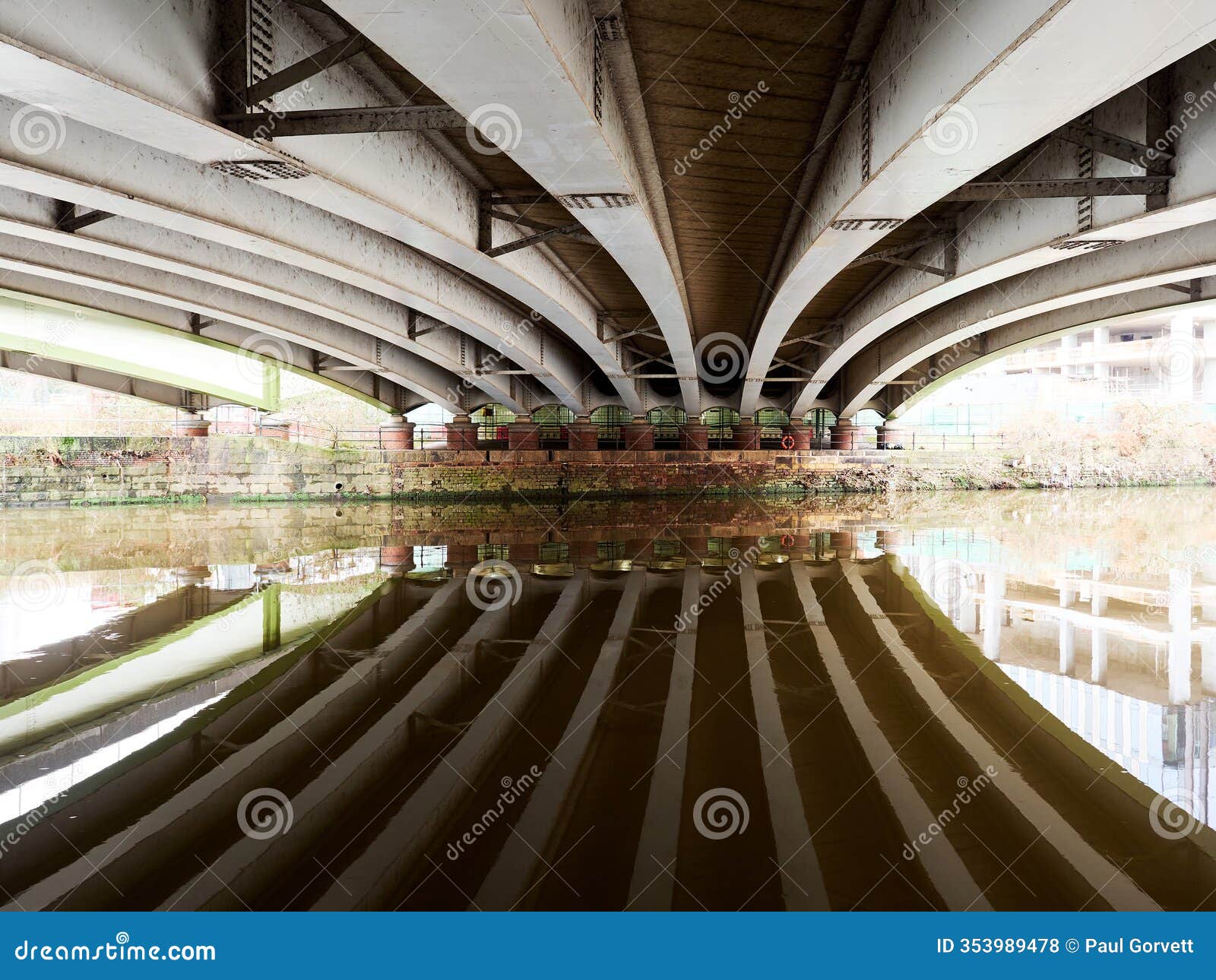 Symmetrical View Beneath a Bridge with Reflective Water Surface Stock ...