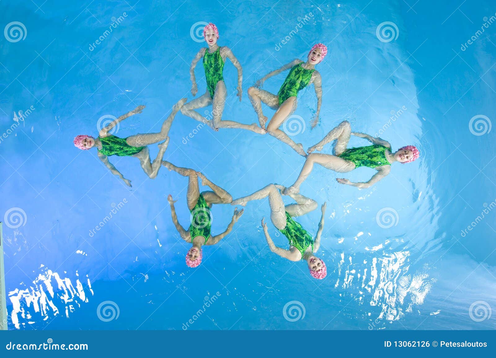 Synchronized Swimmers Take A Pose Underwater In A Pool Stock ...